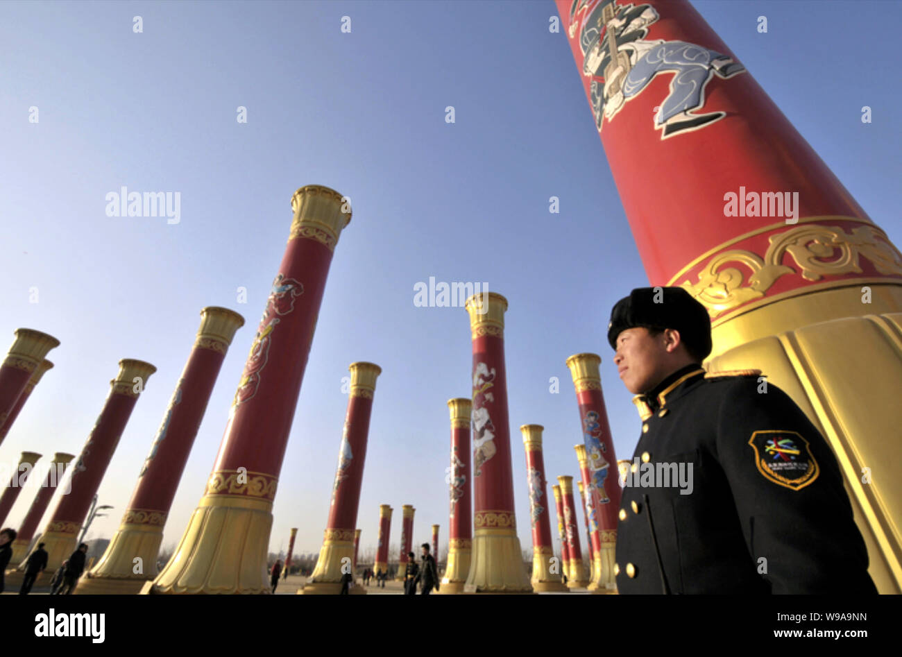 Chinese residents walk past the Columns of National Unity in the ...
