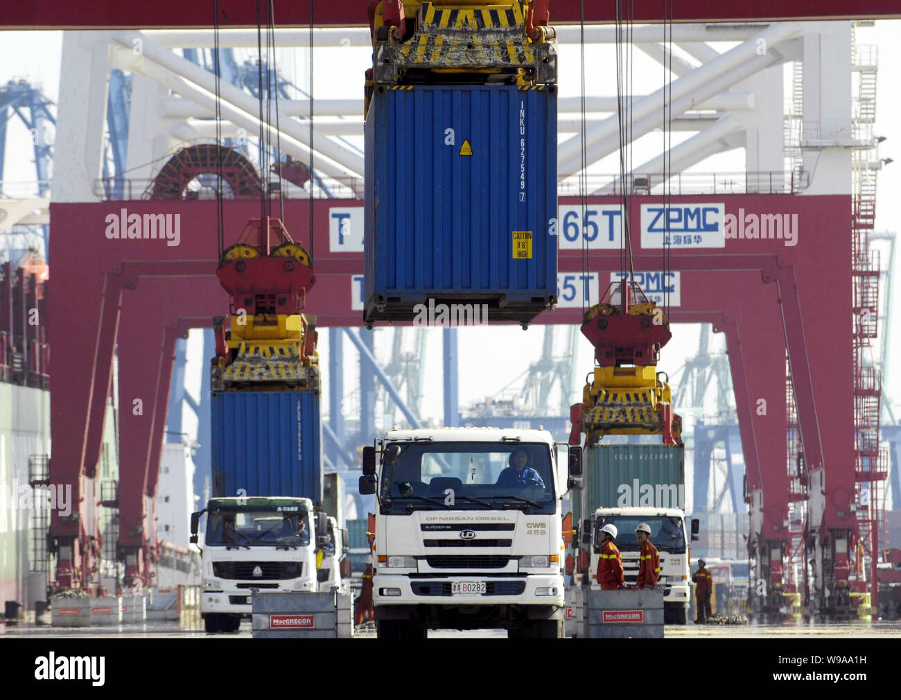 --FILE--Cranes load trucks with containers at a container terminal of ...