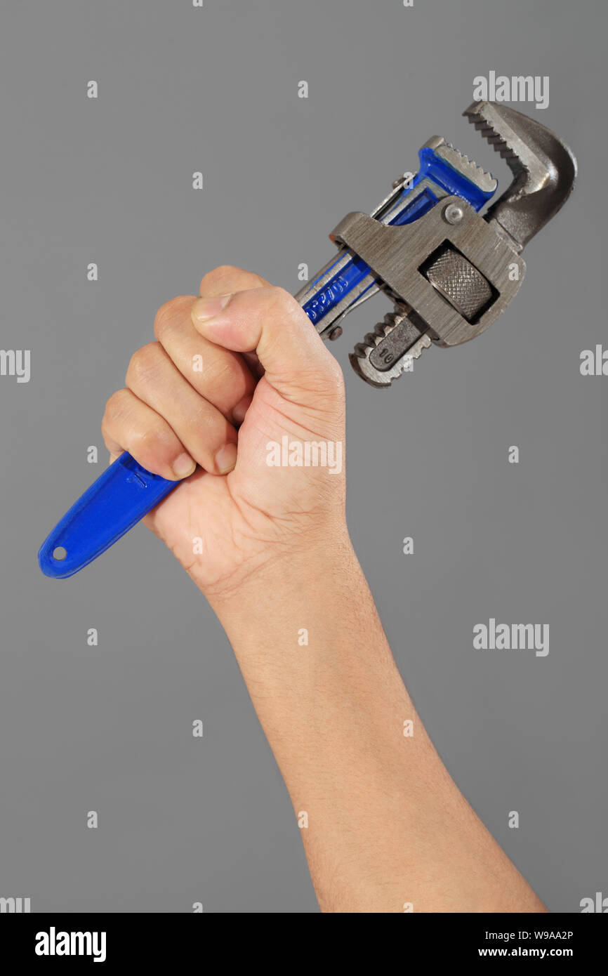Arm holding wrench hi-res stock photography and images - Alamy