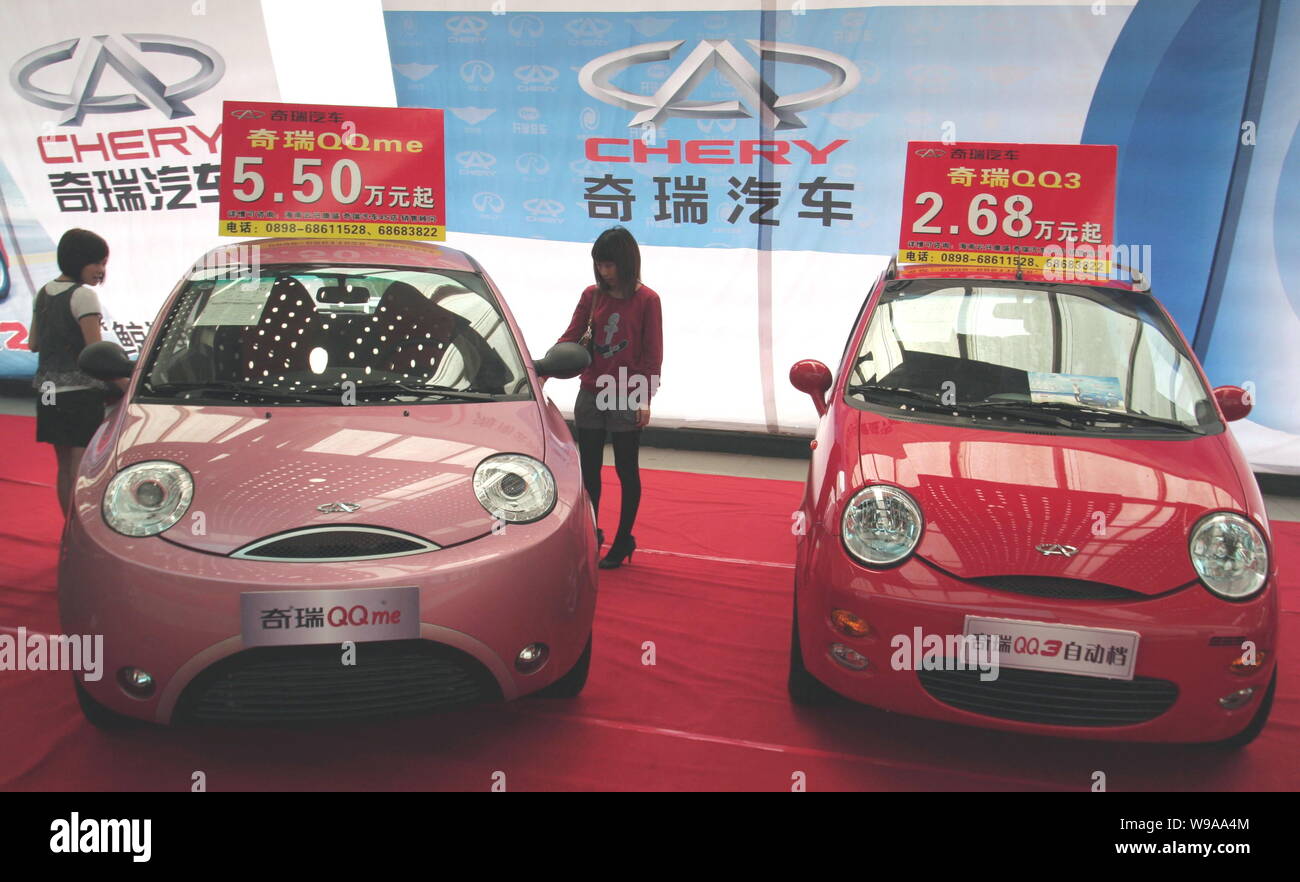 Two young Chinese women look at a Chery QQme during an auto show in Haikou, south Chinas Hainan ...