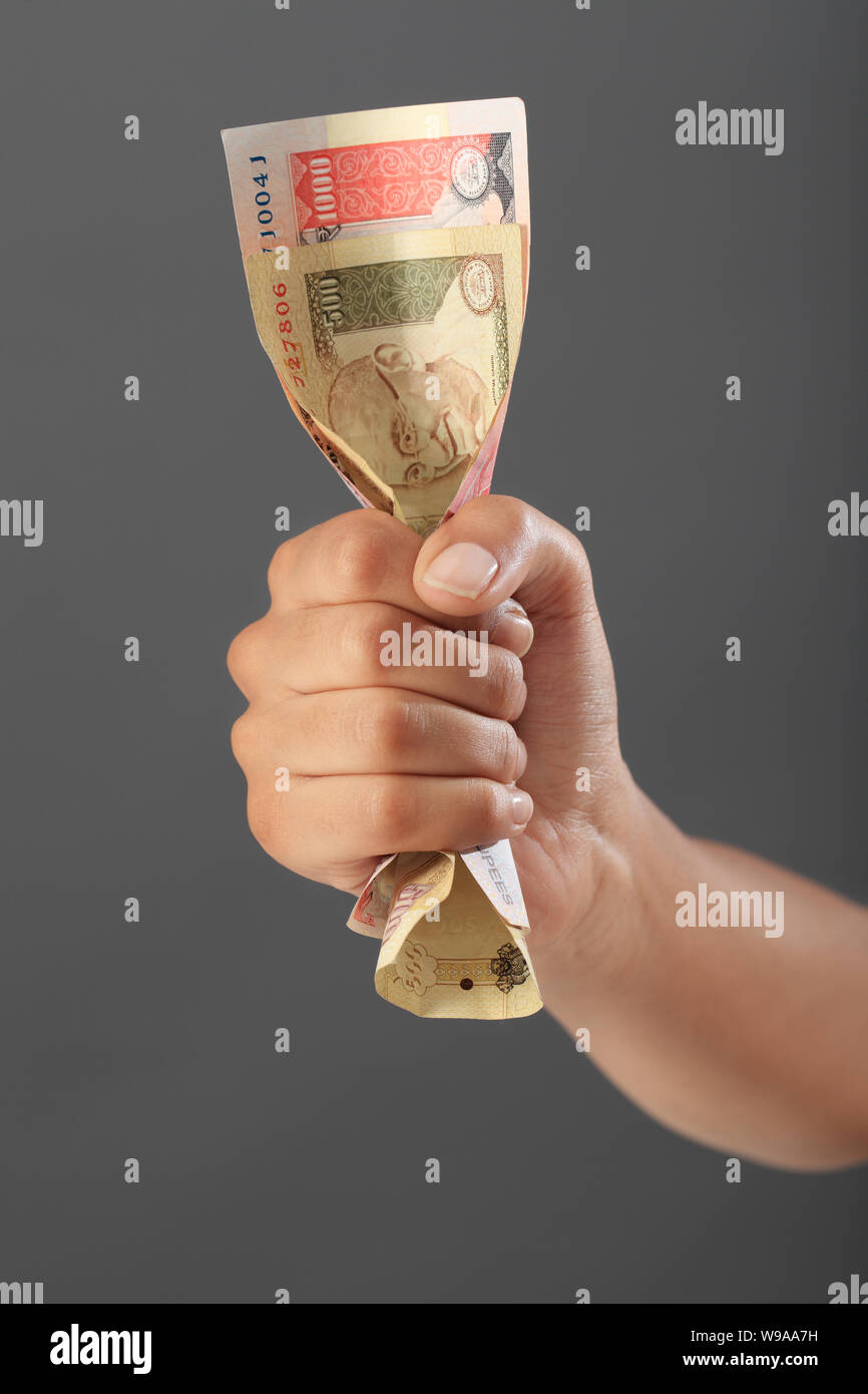 Hand squeezing money hi-res stock photography and images - Alamy