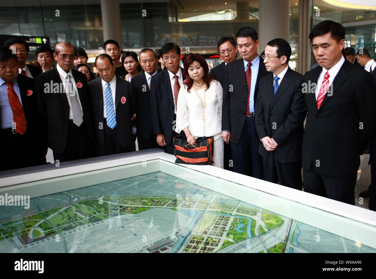 Taipei Mayor Hau Lung-bin (R1) looks at a map of the Hongqiao Airport ...