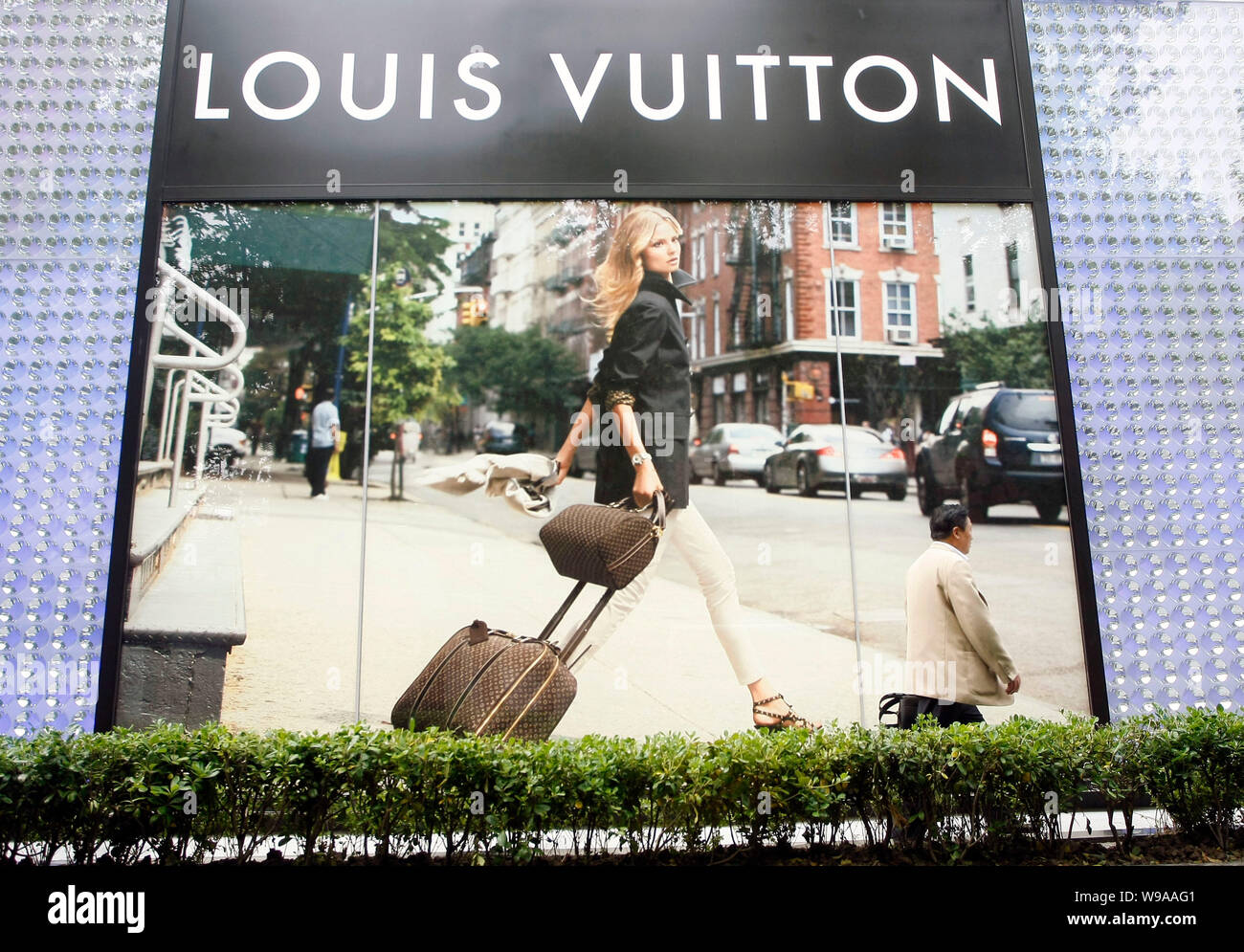 A Chinese man walks past a newly-opened Louis Vuitton (LV) flagship ...