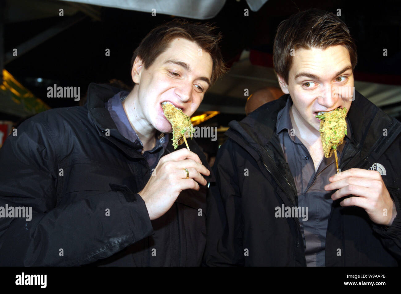 English actor James Phelps and Oliver Phelps eat snack food at a night ...