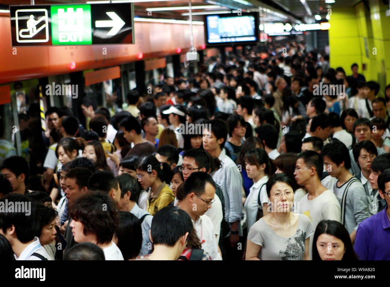 --FILE--Crowds of passengers walk in and out of a train of the ...