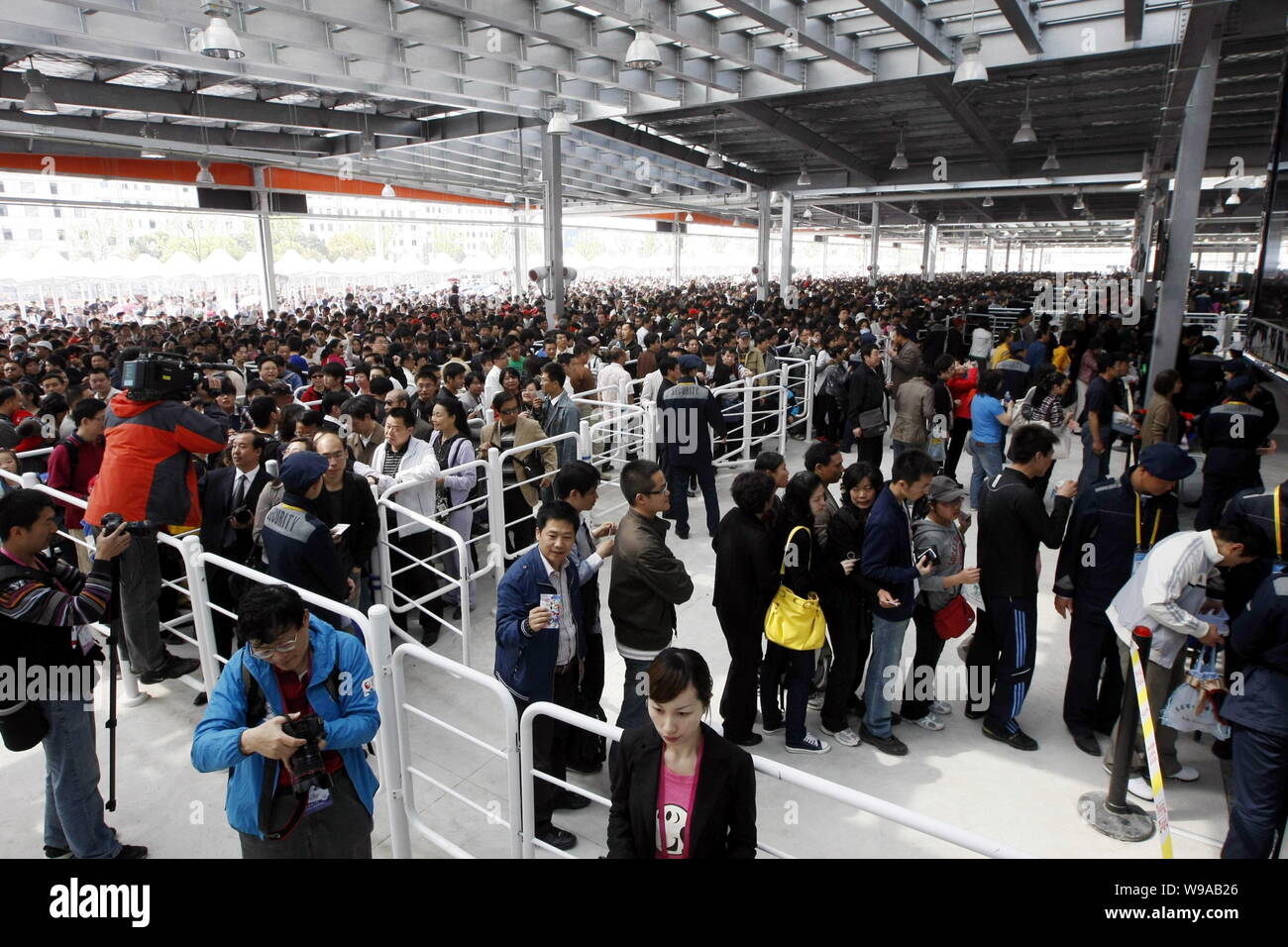 Crowds of visitors queue up to enter the Expo site on the first day ...