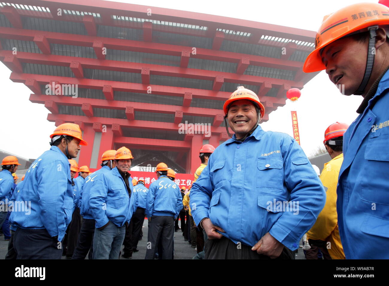 Chinese construction workers are seen during the completion ceremony of ...