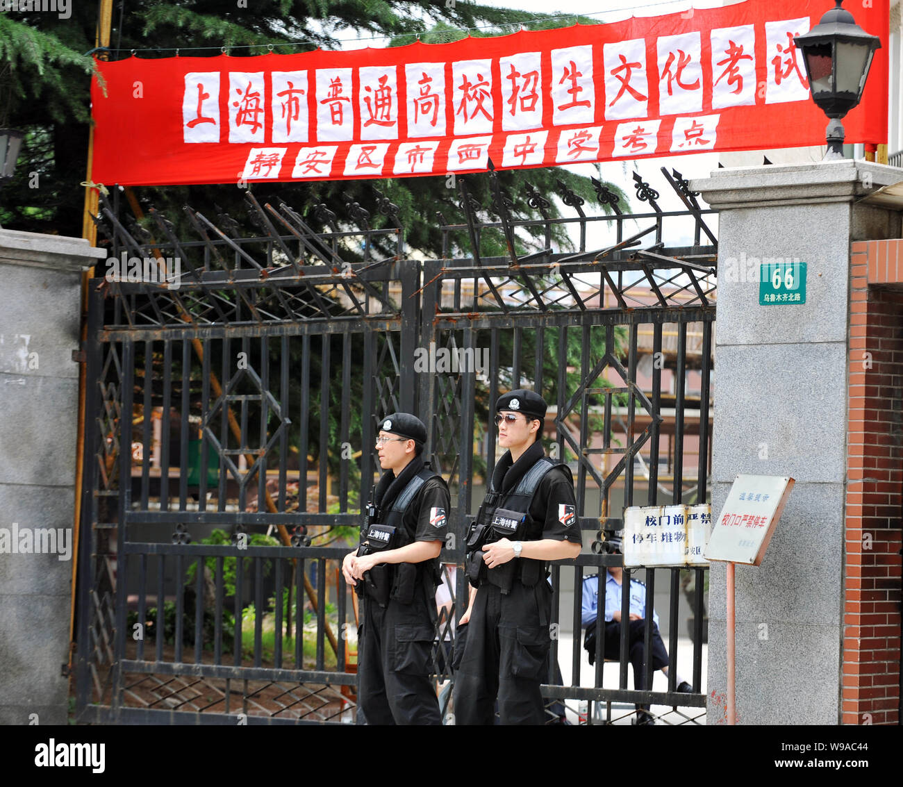 Chinese special police officers stand guard outside a school where ...