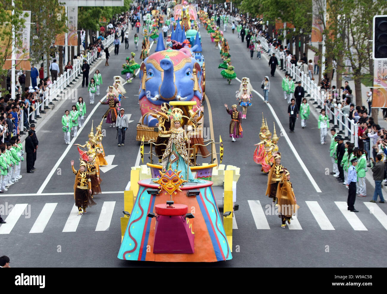 Visitors look at entertainers performing during a parade in the World ...