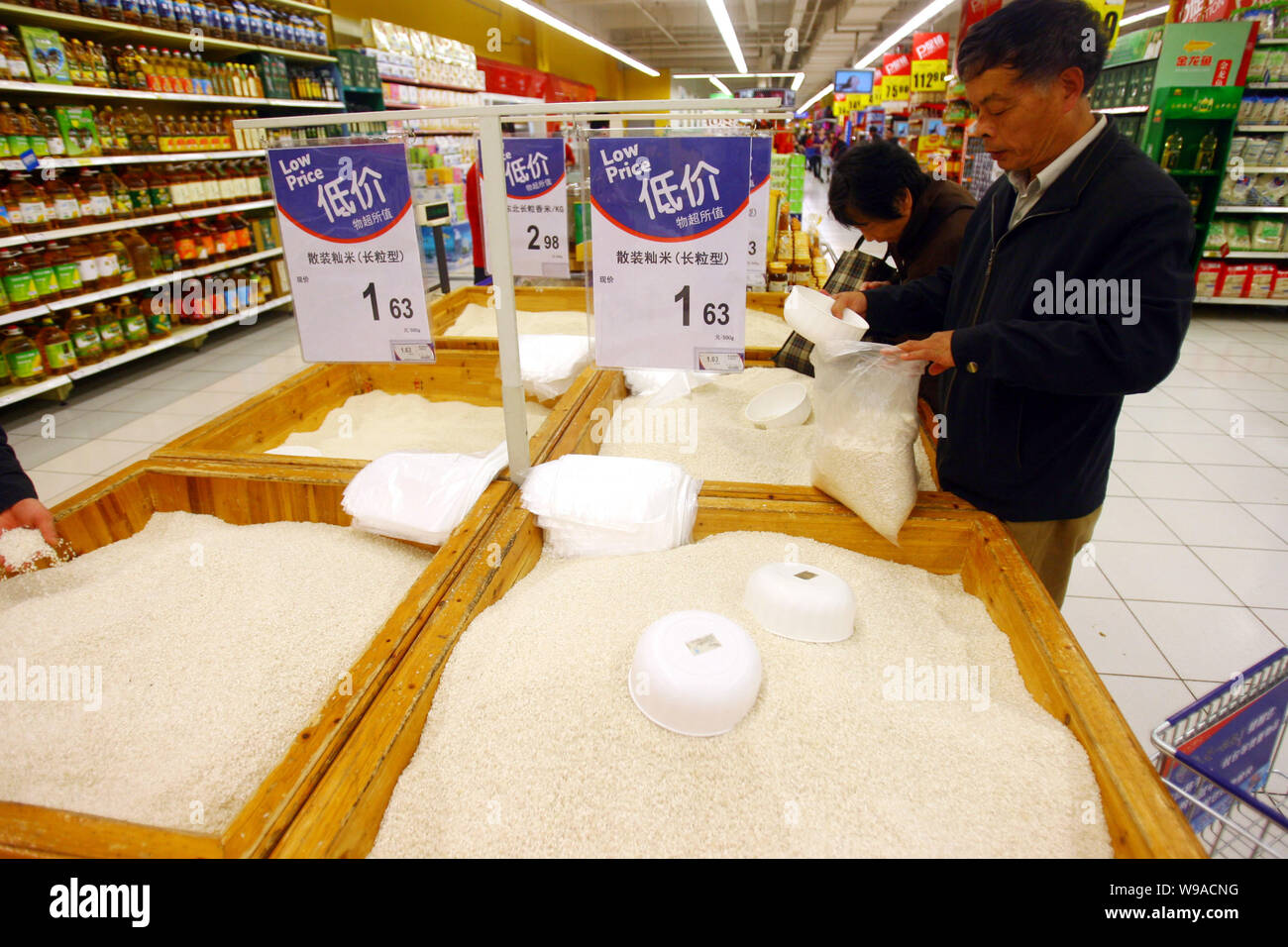 Chinese customers shop for rice at a supermarket in Ningbo city, east ...
