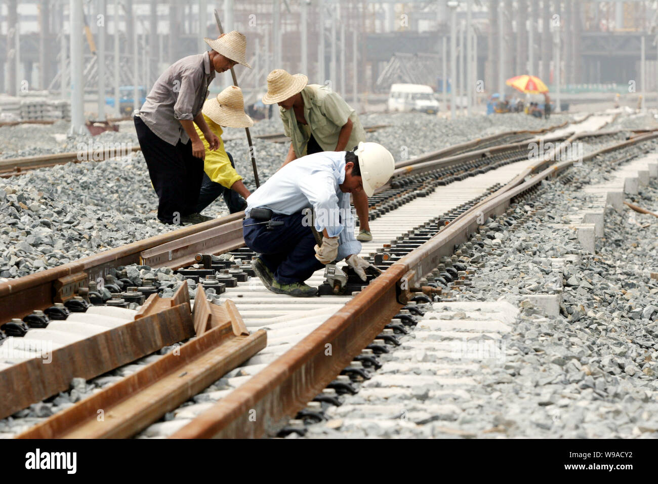 --FILE--Chinese construction workers lay tracks of the Beijing-Shanghai ...