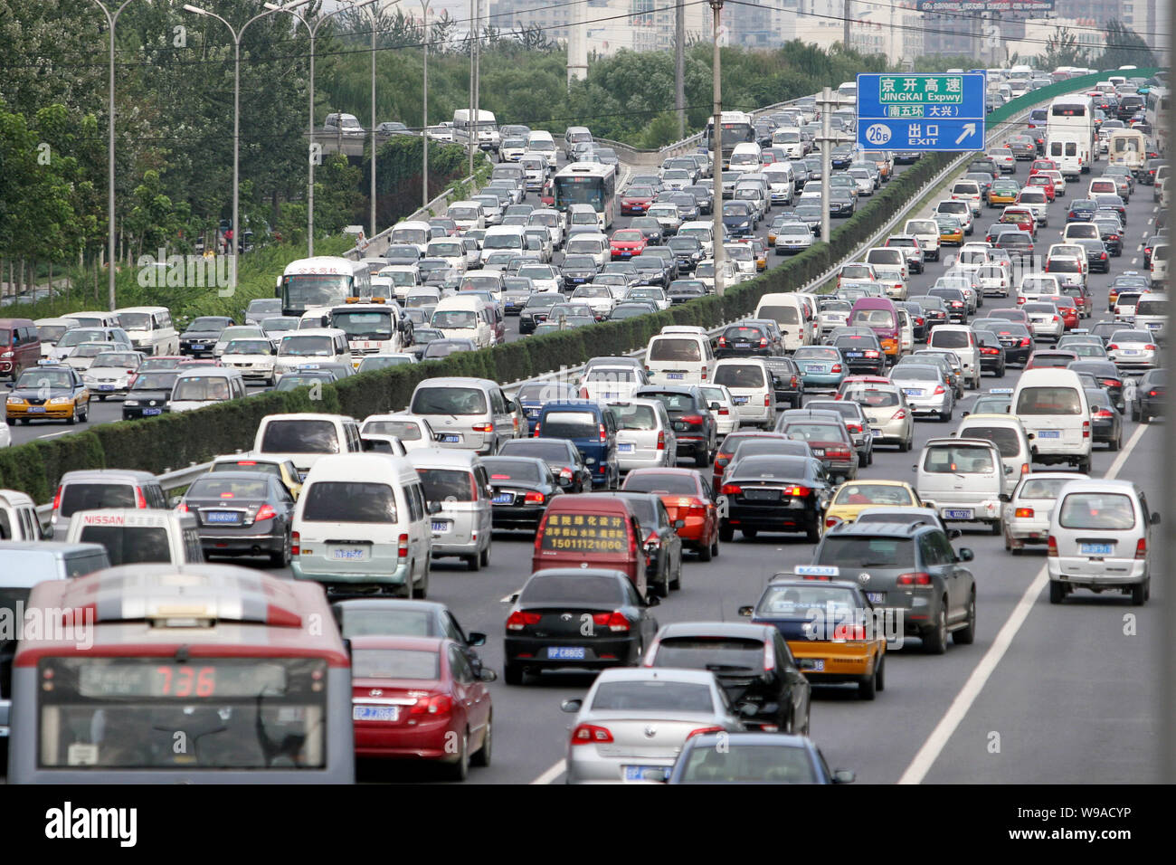 Masses of vehicles move slowly in a traffic jam on a road in Beijing ...