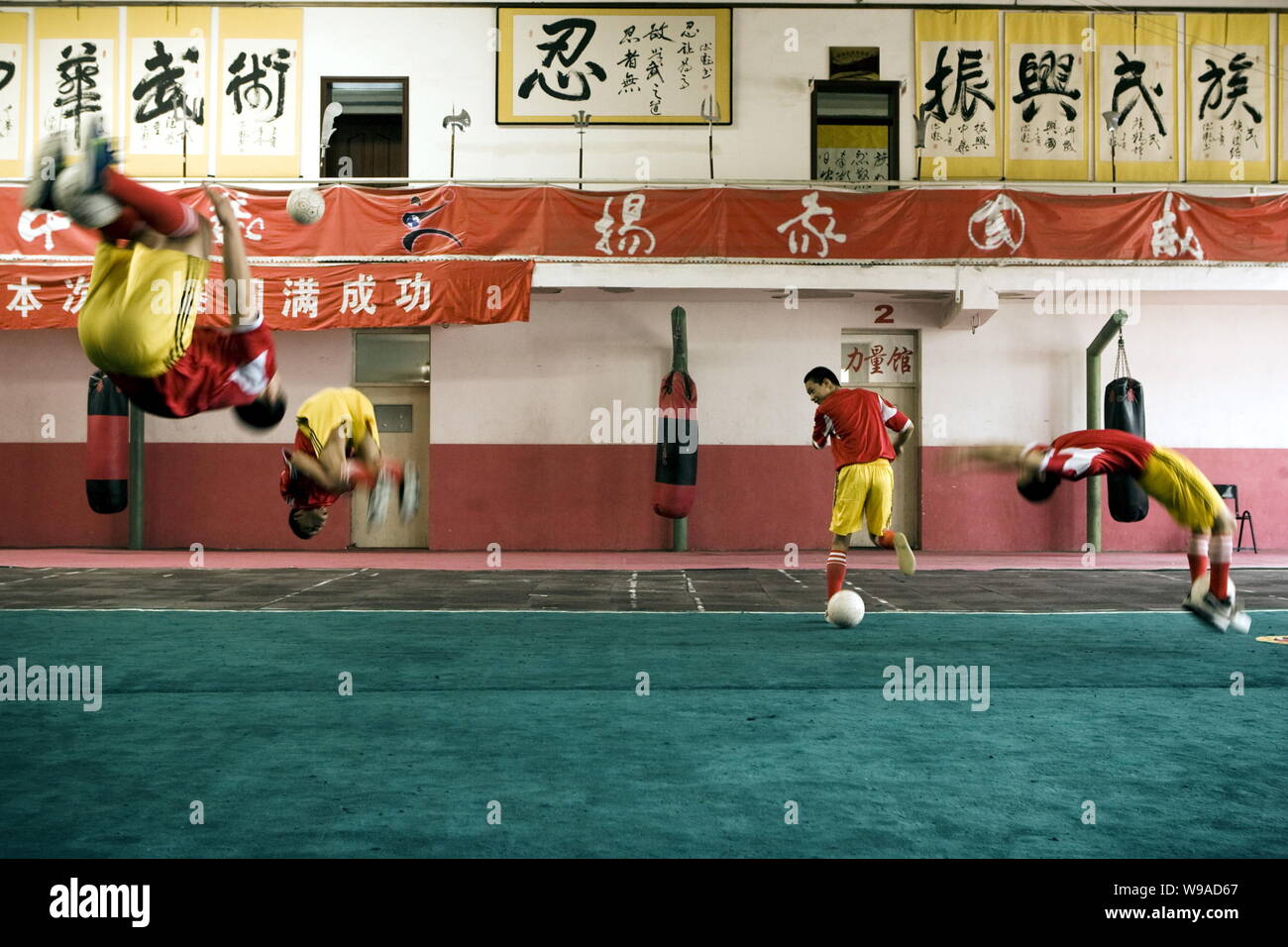 Chinese kungfu football players gripping footballs with their feet make ...