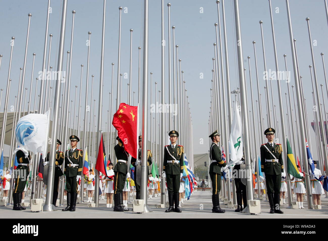 Chinese soldiers raise flags during the flag-raising ceremony in the ...