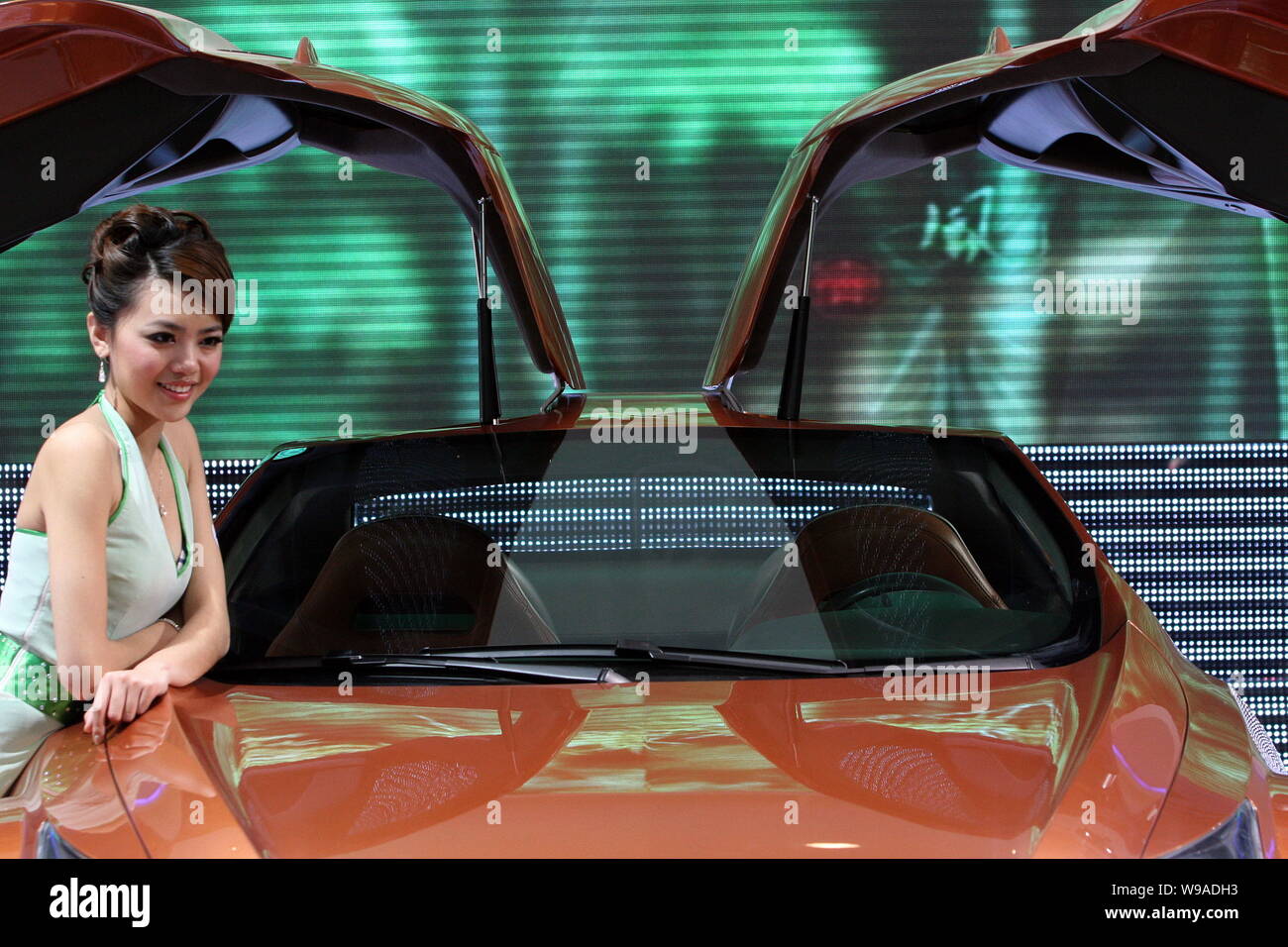 A model poses next to the IAT Cross Wind II EV Concept at the 11th ...