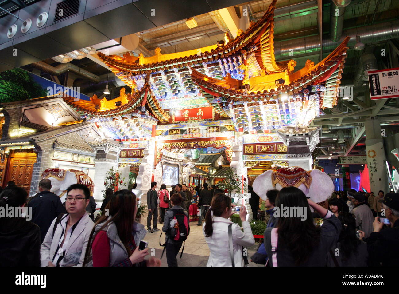 Visitors crowd the Yunnan Pavilion in the Expo site in Shanghai, China ...