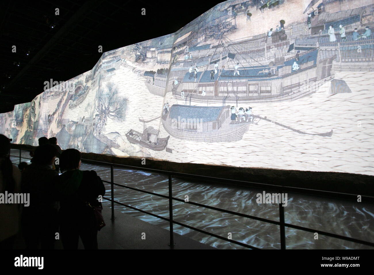 Visitors look at the projection of the painting, Riverside Scene at ...