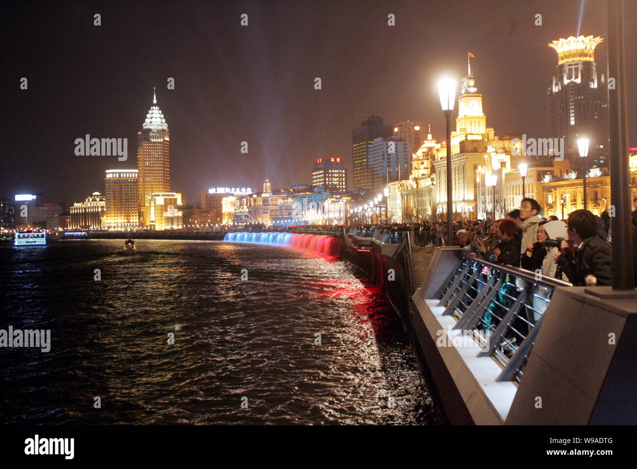 Night view of tourists and local residents crowding the promenade on ...