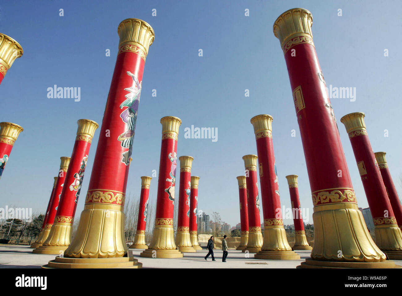Chinese residents walk past the Columns of National Unity in the ...