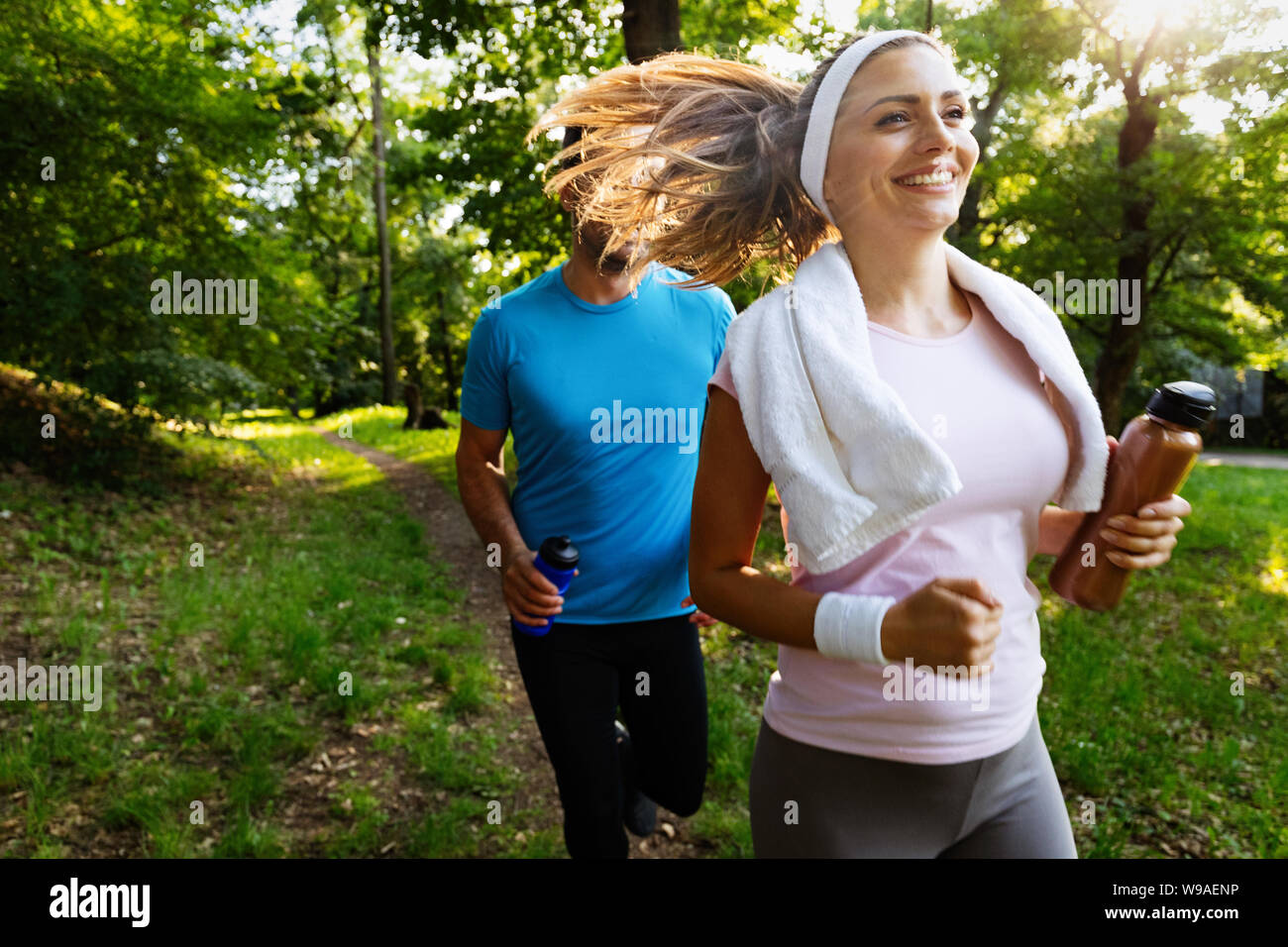 Happy couple running and exercising together outdoor Stock Photo - Alamy