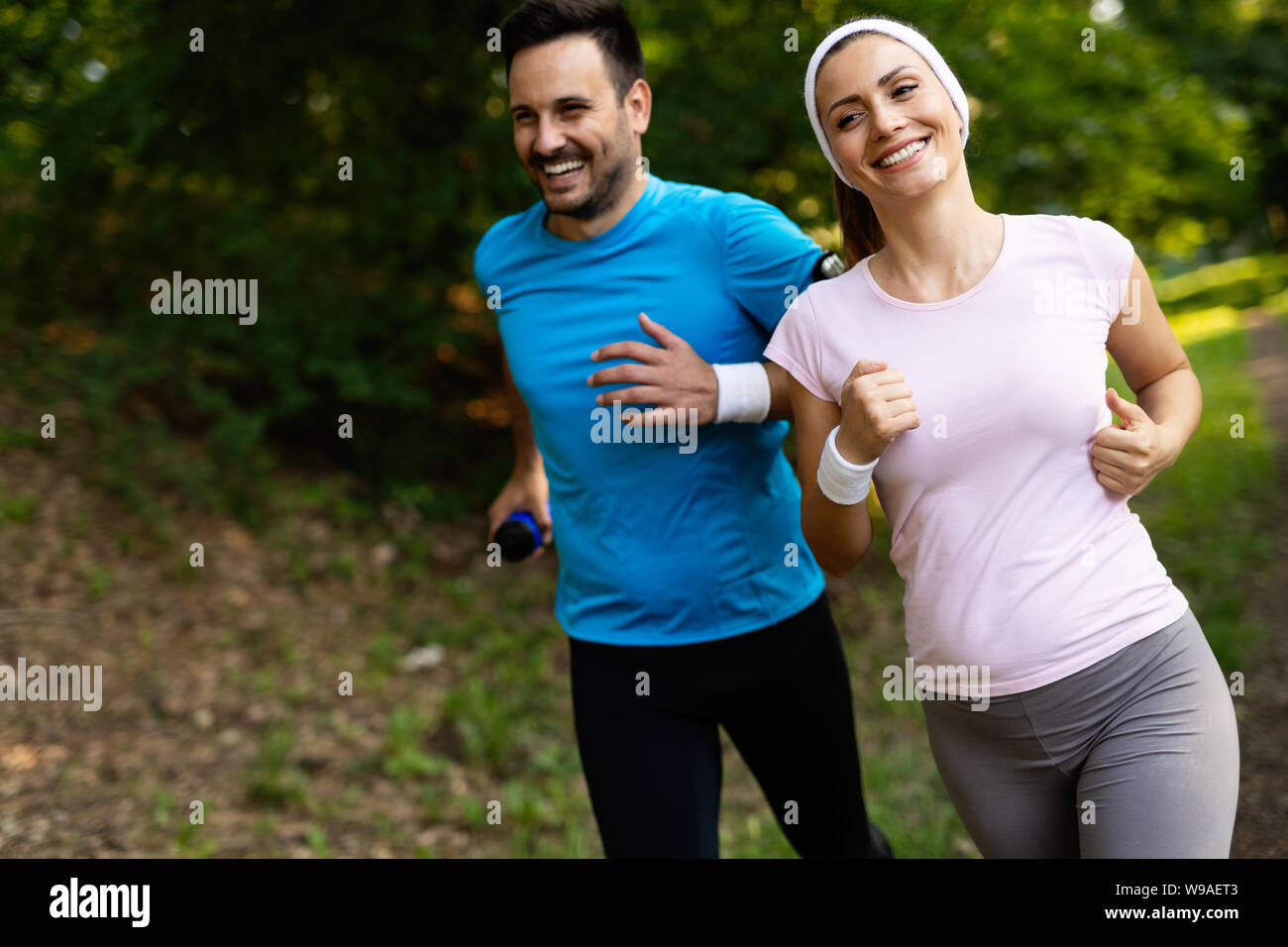Young fitness couple running forest hi-res stock photography and images ...