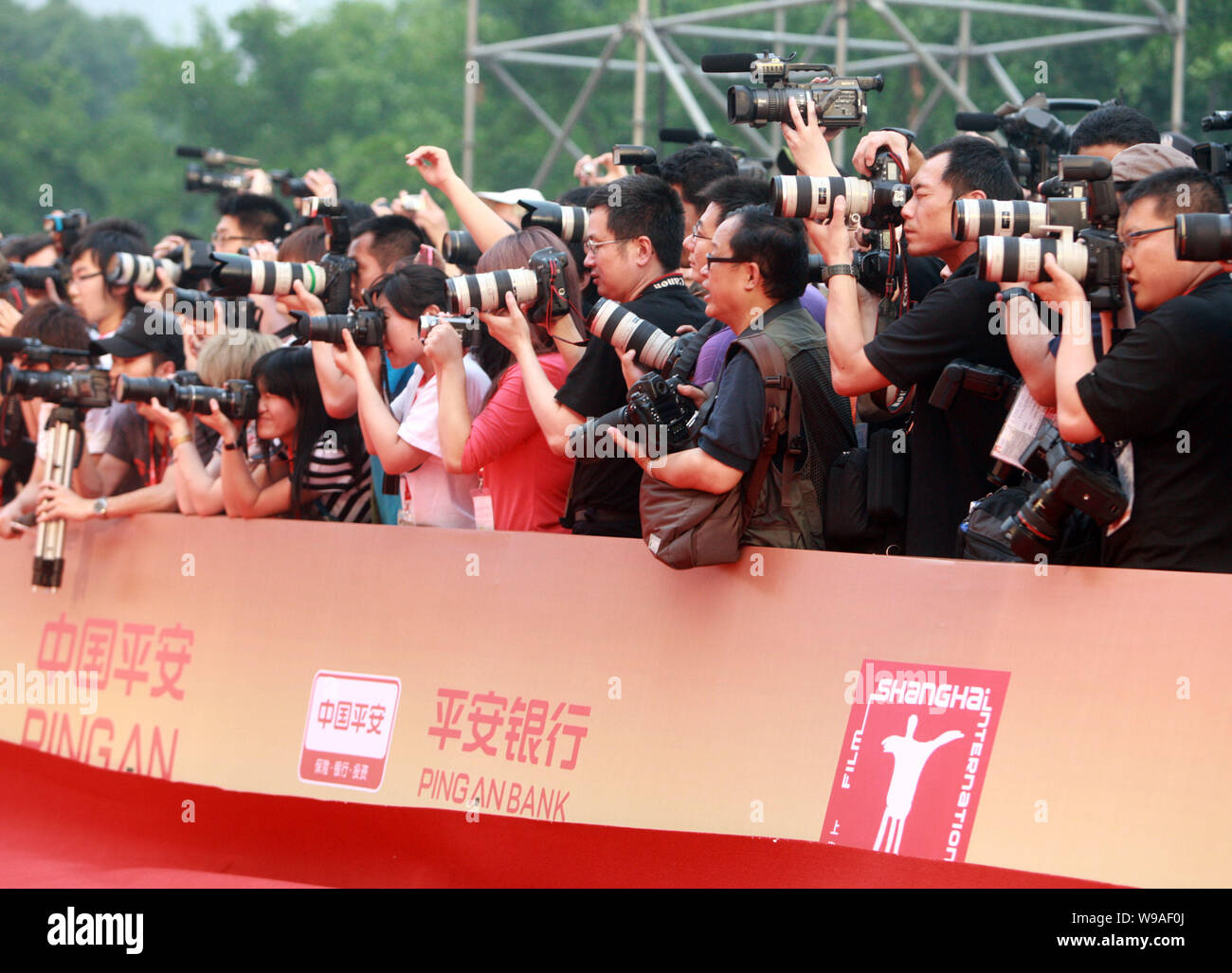 Photographers take photos of stars walking on the red carpet before the ...