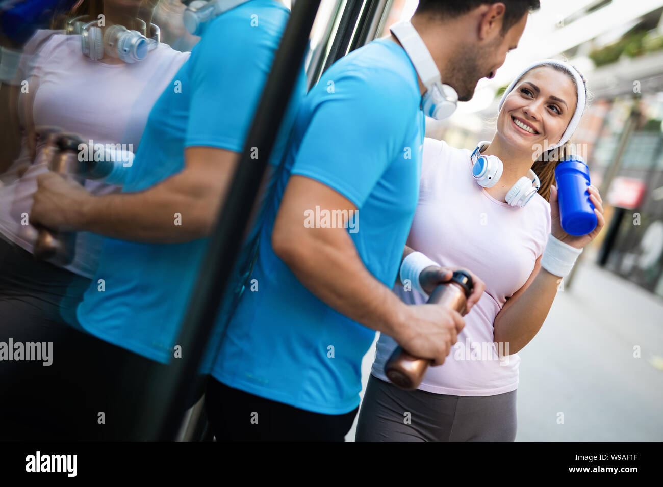 Fitness sporty couple relaxing after running training outside Stock Photo - Alamy