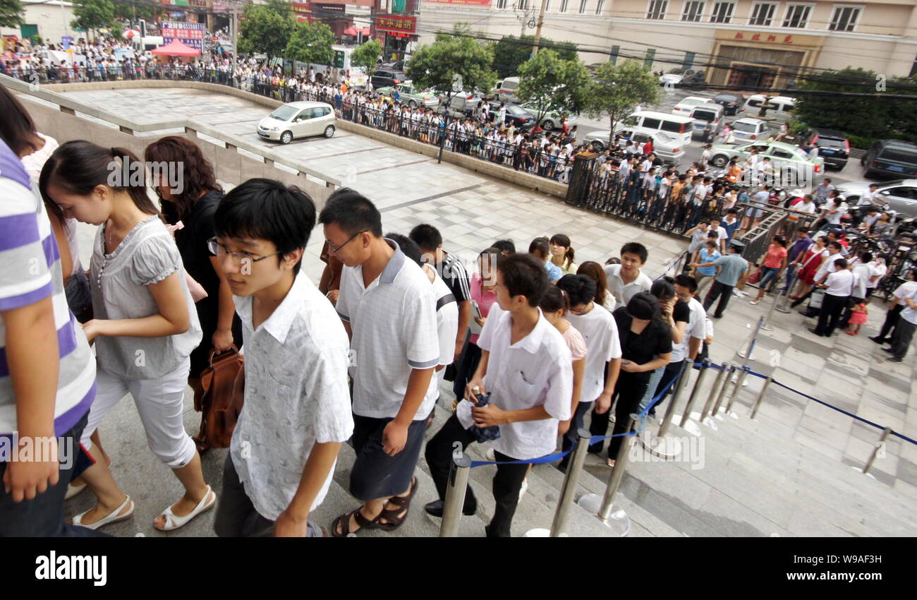 A crowd of Chinese jobseekers queue up to enter a job fair to look for ...