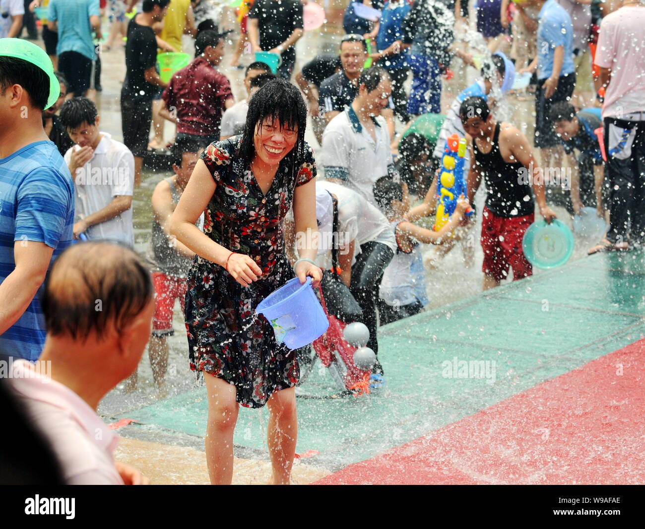 Chinese people splash water in a big fountain to save water during a ...