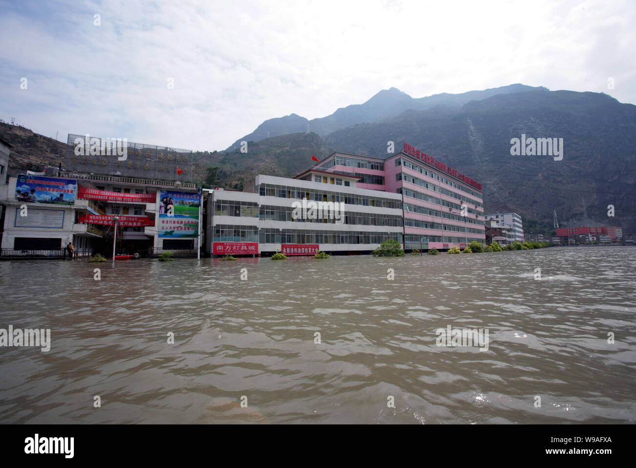 Buildings are partly submerged in the floodwater after the mudslide ...