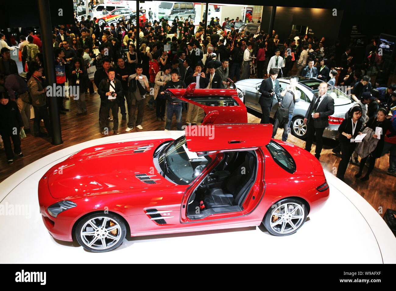 Visitors look at a Mercedes-Benz SLS AMG during the 11th Beijing ...