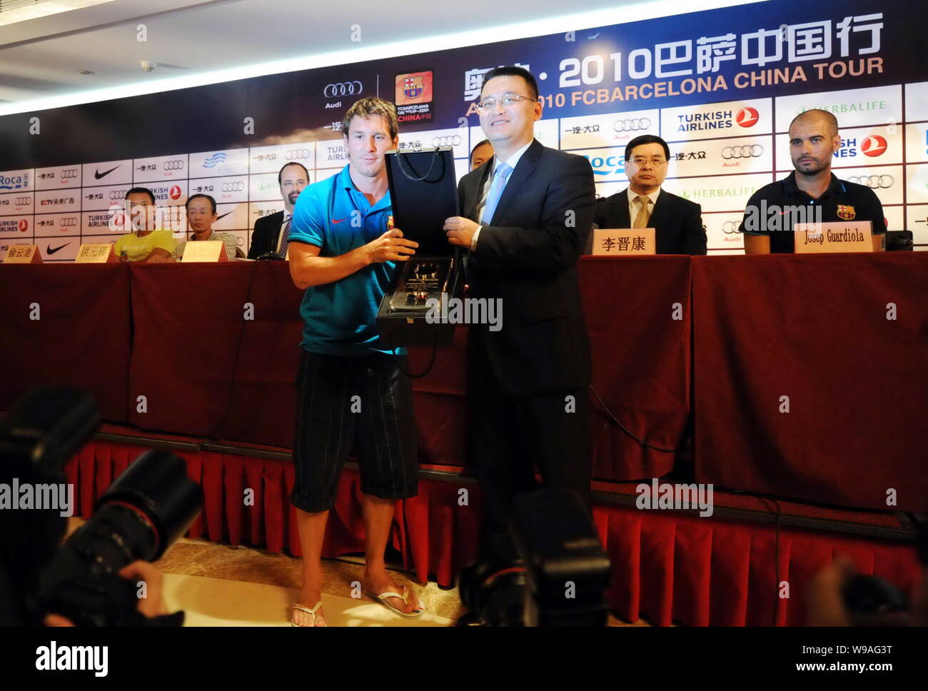 A Chinese official presents a gift to Argentine soccer player Lionel ...