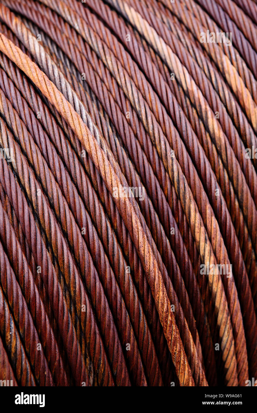 Background image of a spool of old industrial metal cable Stock Photo ...