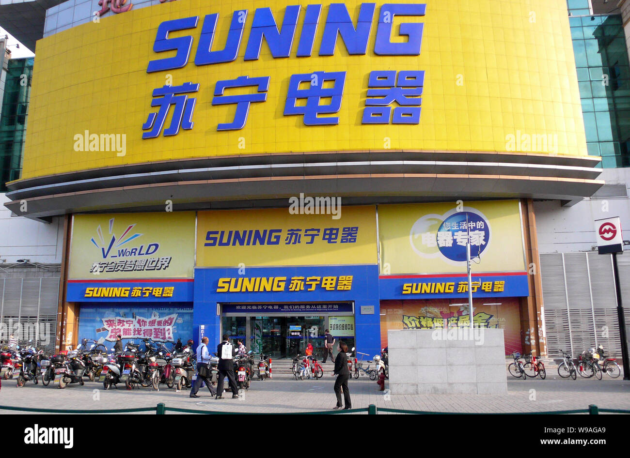--FILE--Local Chinese residents walk past a Suning home appliance chain ...