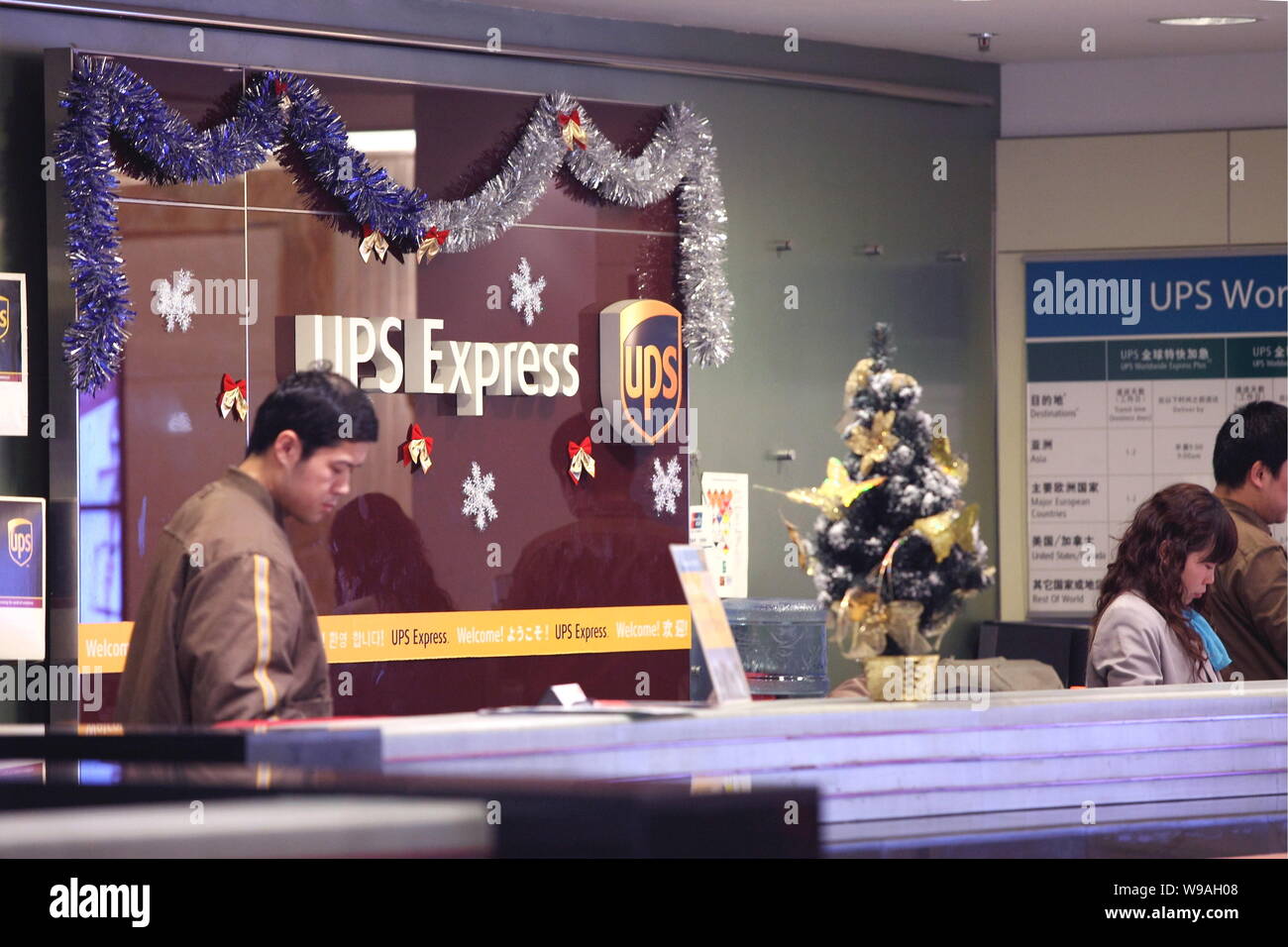 Chinese staff are seen at a branch of UPS Express in Shanghai, China ...