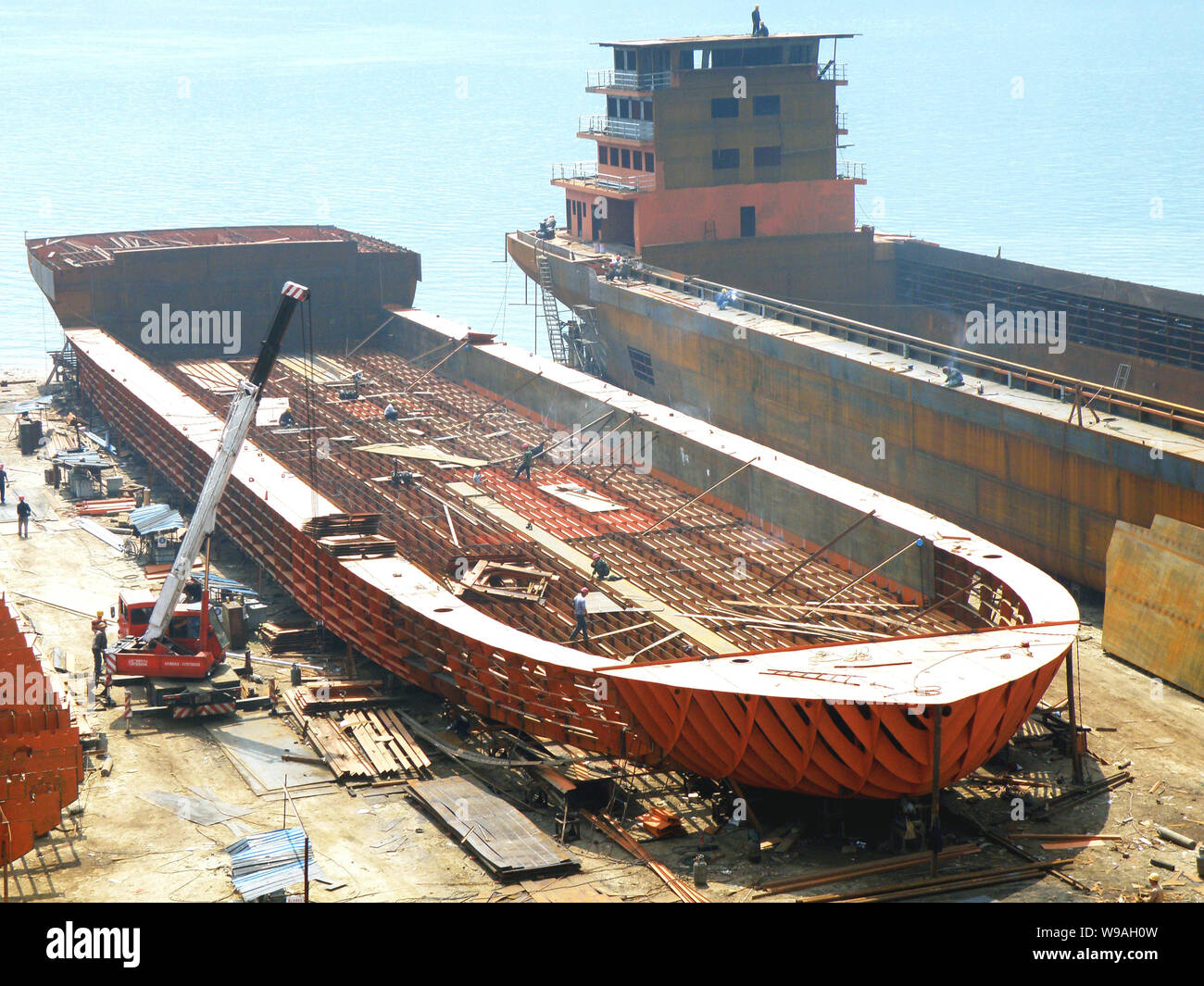 Chinese workers build a ship at a shipyard in Yichang city, central ...