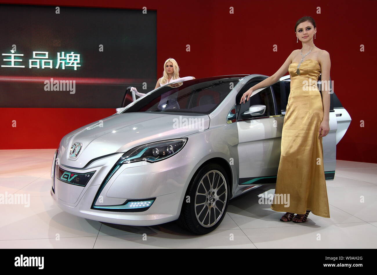 Models pose by a C30EV of Beijing Automotive during the 11th Beijing ...