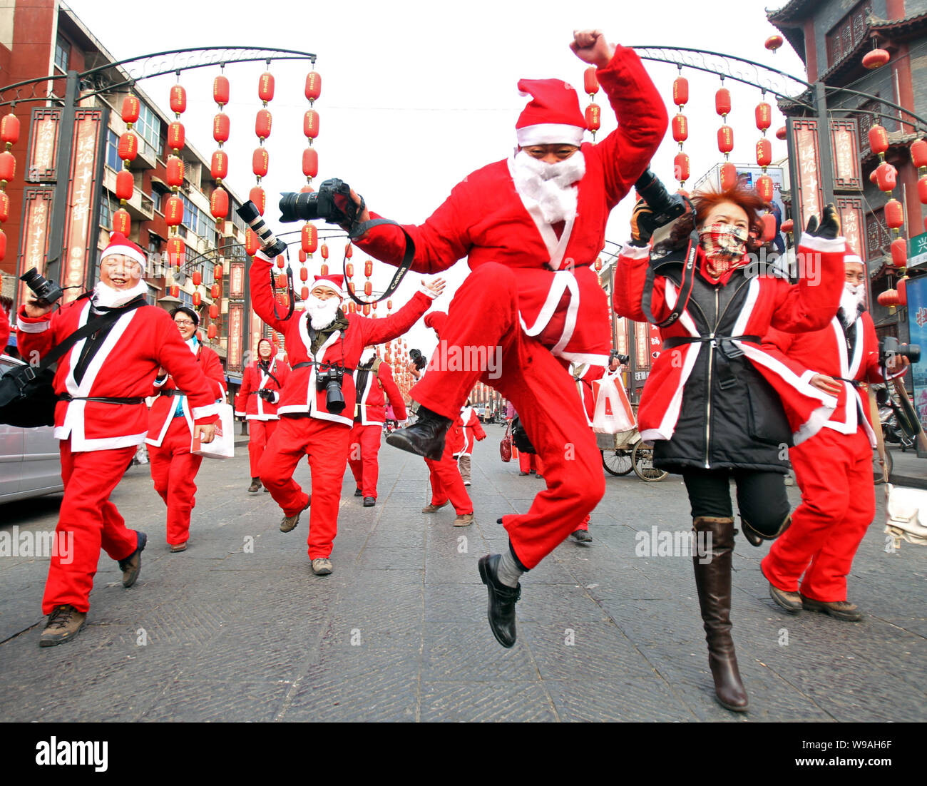 Chinese photography fans dressed in Santa Claus costumes parade on the ...