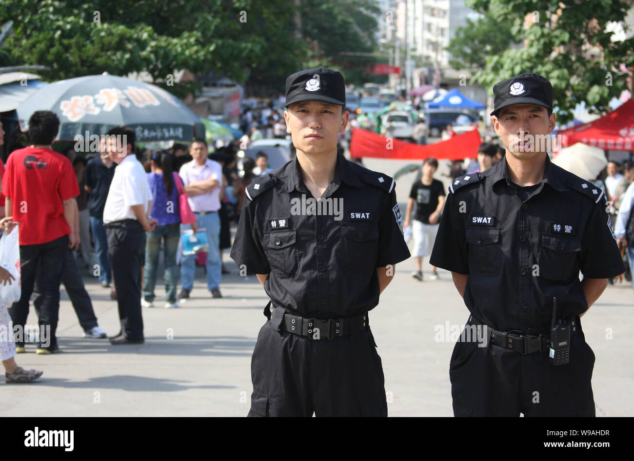 Chinese special police officers stand guard outside a school prior to ...