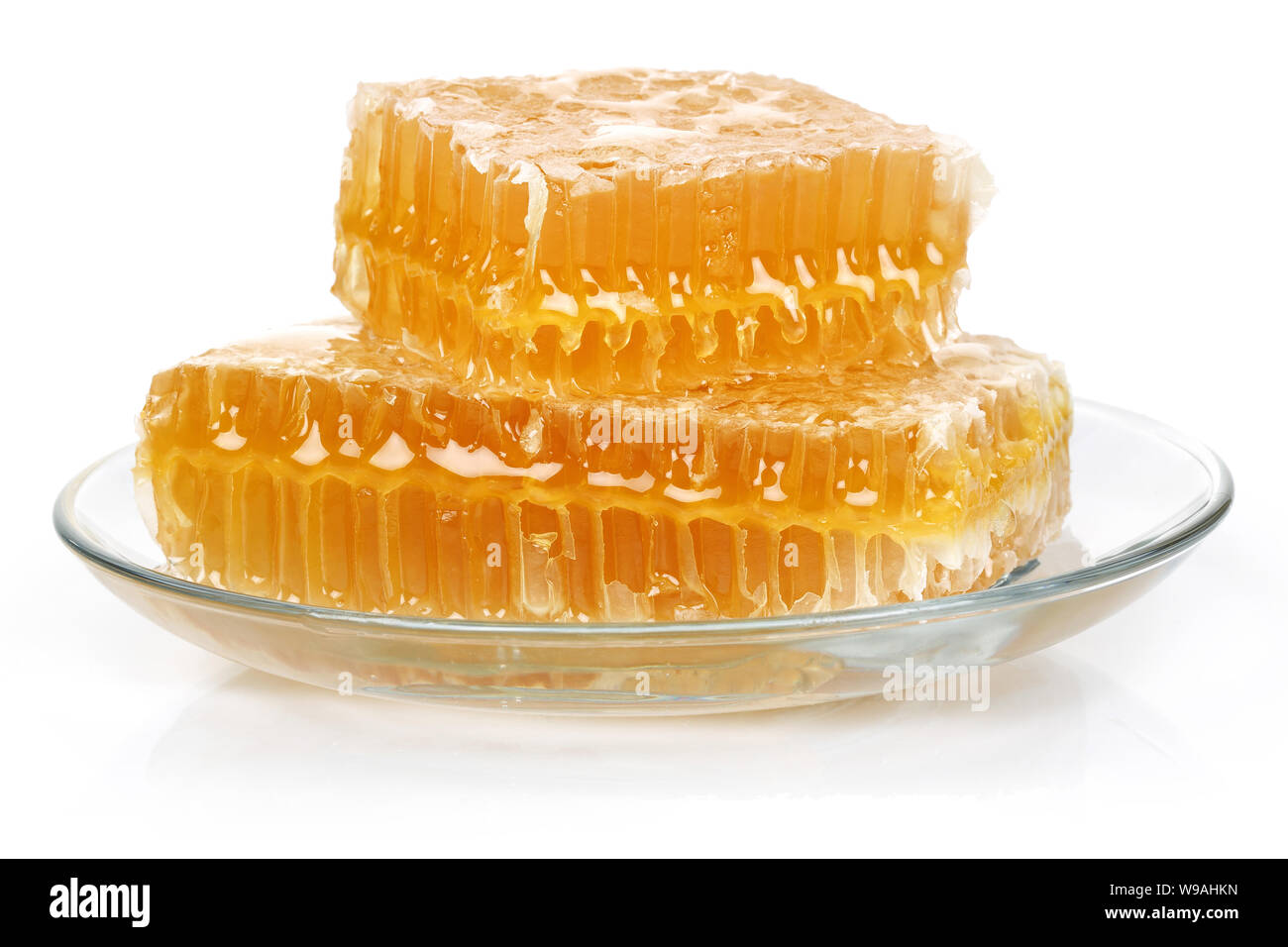 Honeycomb in glass dish isolated on white background Stock Photo - Alamy
