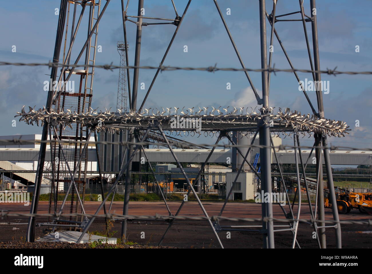 Very sharp coils mounted around the base area of a tall galvanised ...