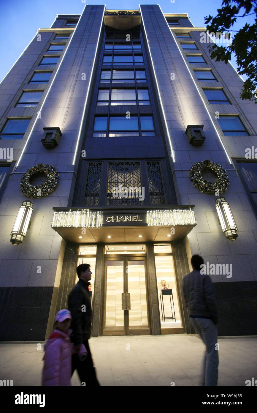 Chinese residents walk past the Chanel boutique at the Peninsula Hotel ...