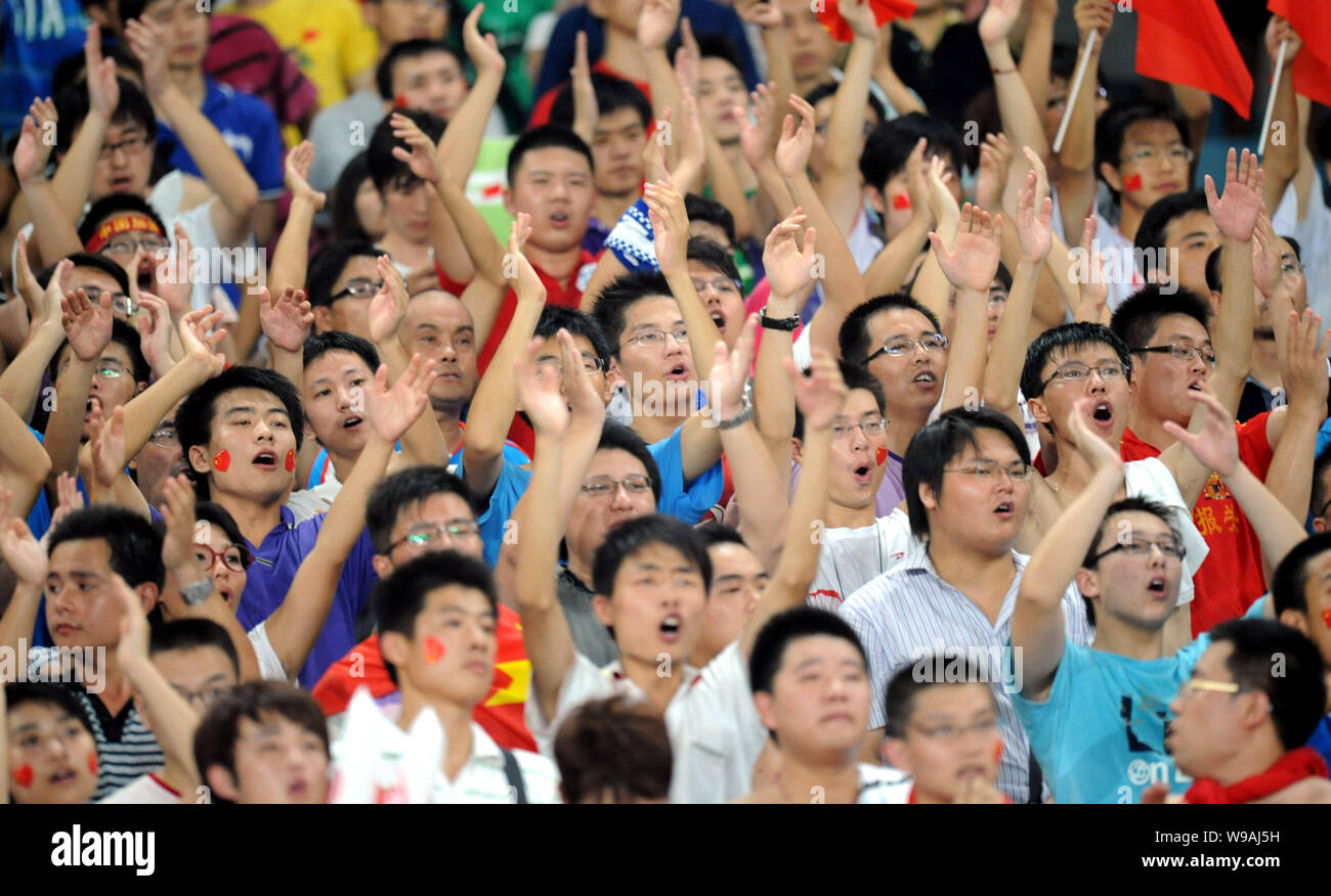 Chinese football fans cheer in a friendly soccer match between China ...