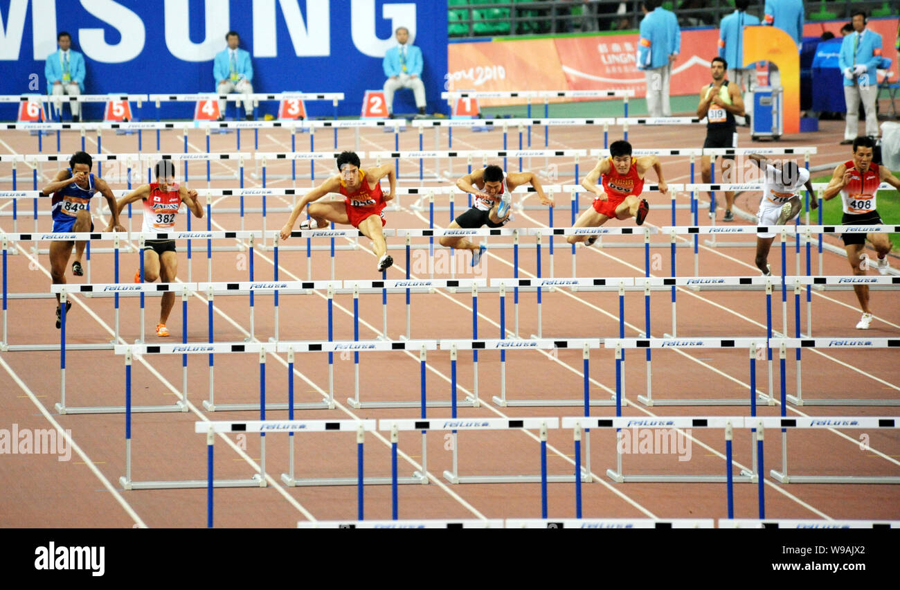 Chinas star hurdler Liu Xiang, third left, clears a hurdle in the mens ...