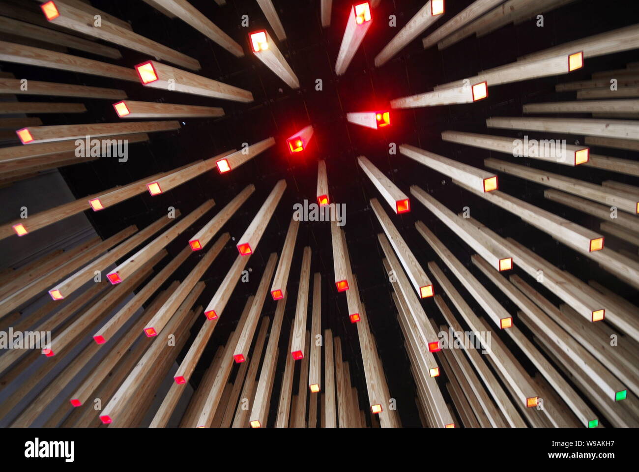 Wooden sticks installed with lights are hung on the ceiling of the ...
