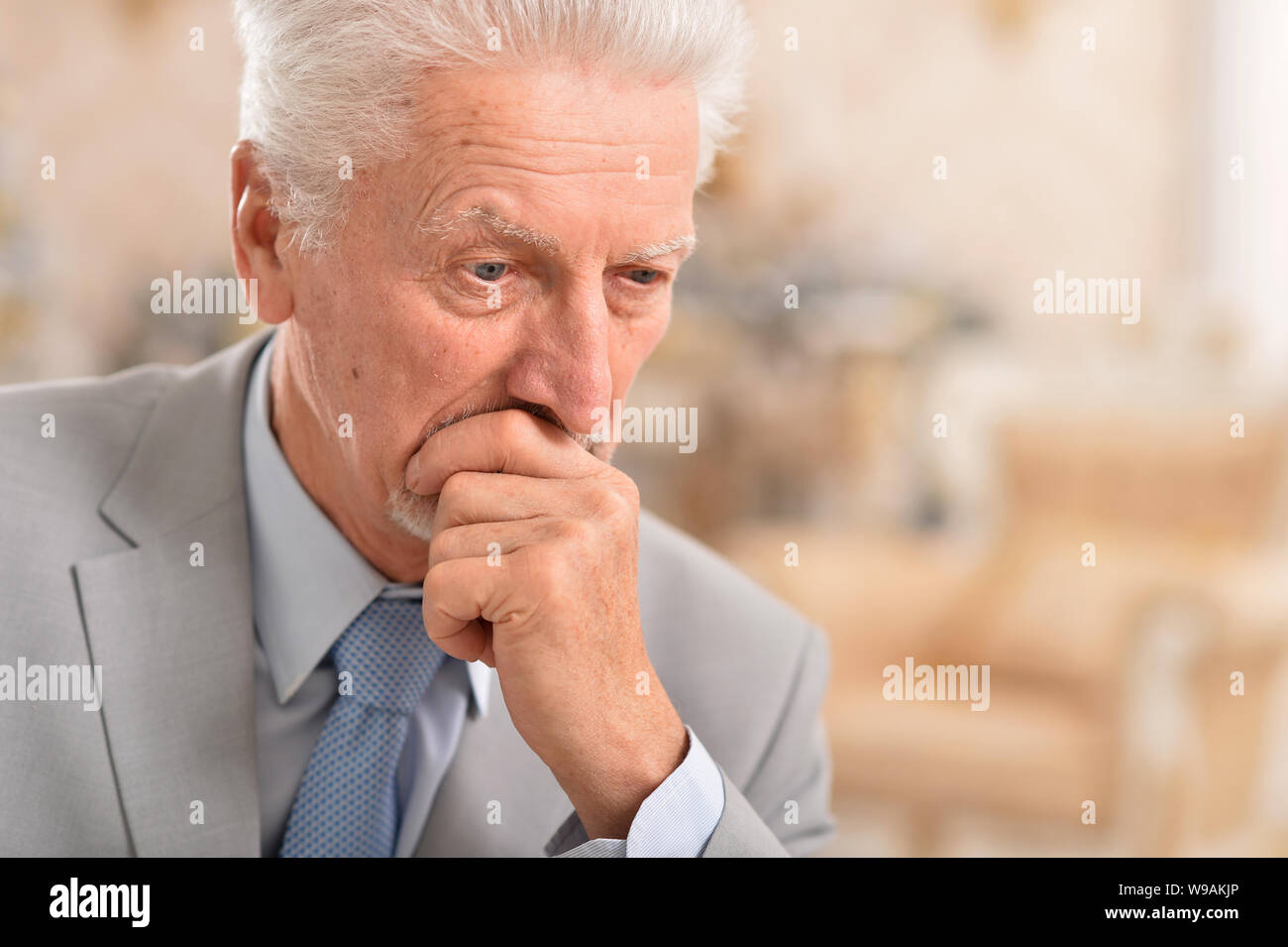 Portrait of intelligent elderly business man thinking at home Stock ...