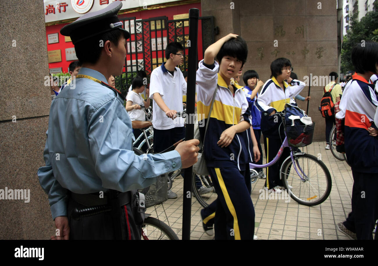 A Chinese security guard stands guard at the entrance of a primary ...