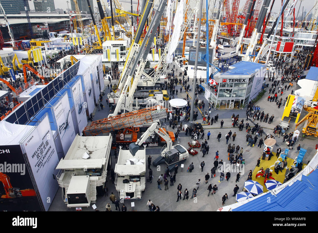 Visitors look at construction machineries during the 2010 International ...