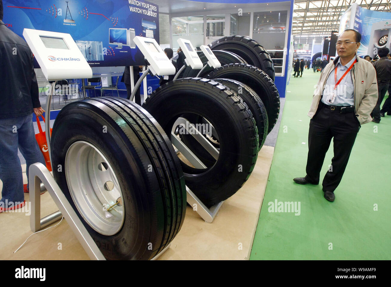 --FILE--Chinese visitors look at tires on display on the booth of ...
