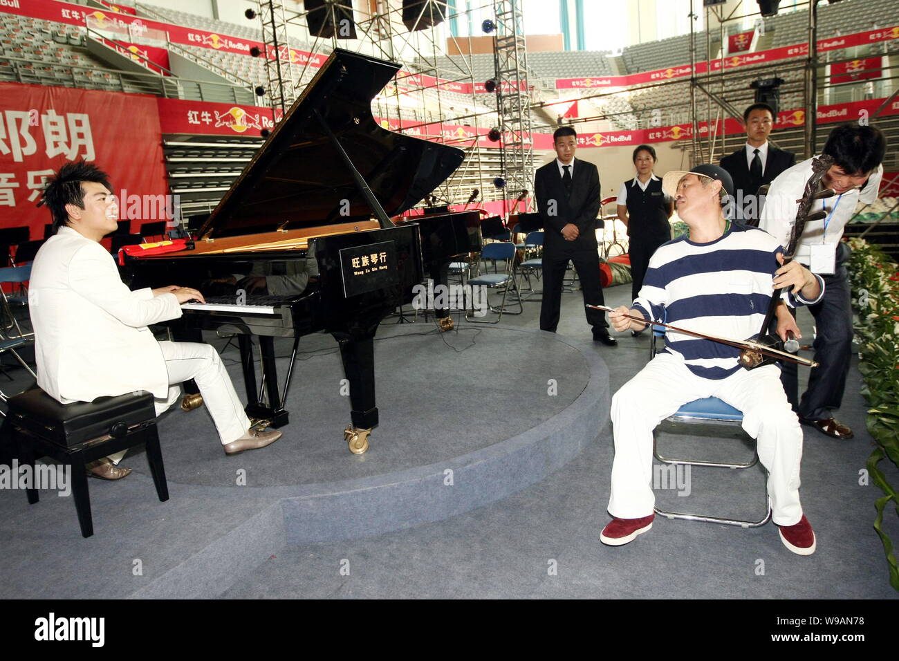 Chinese pianist Lang Lang, left, performs next to Chinese comedian Zhao ...